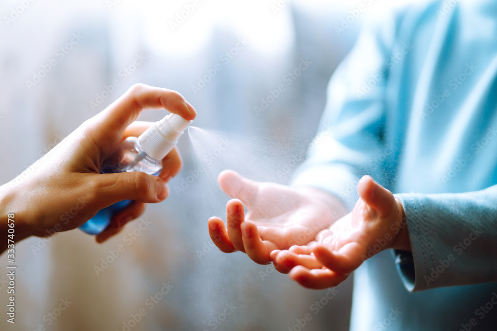 Hands with sanitizer antiseptic. Mother and child using sanitize ...