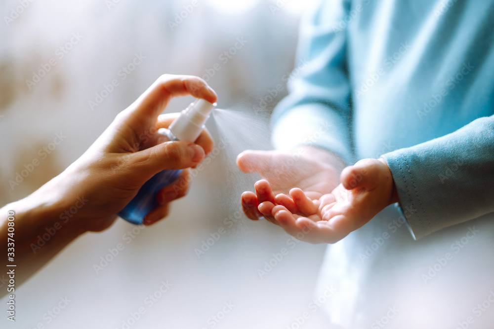 Hands with sanitizer antiseptic. Mother and child using sanitize ...