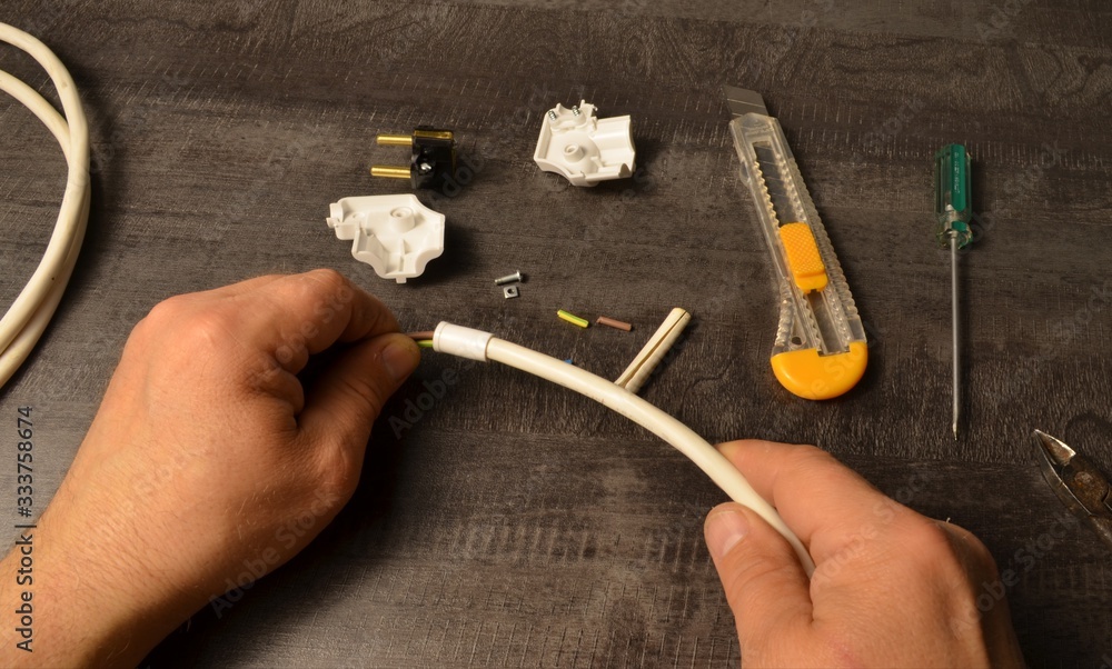 wire stripping for installing an earthed electric plug Stock Photo ...