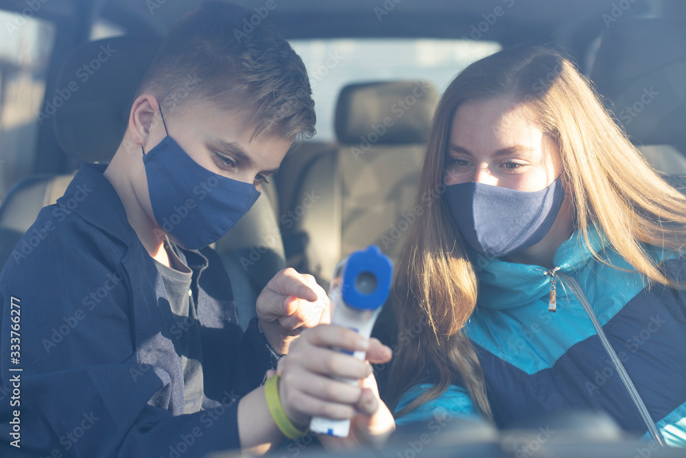 People gets body temperature measured with an infrared non-contact ...