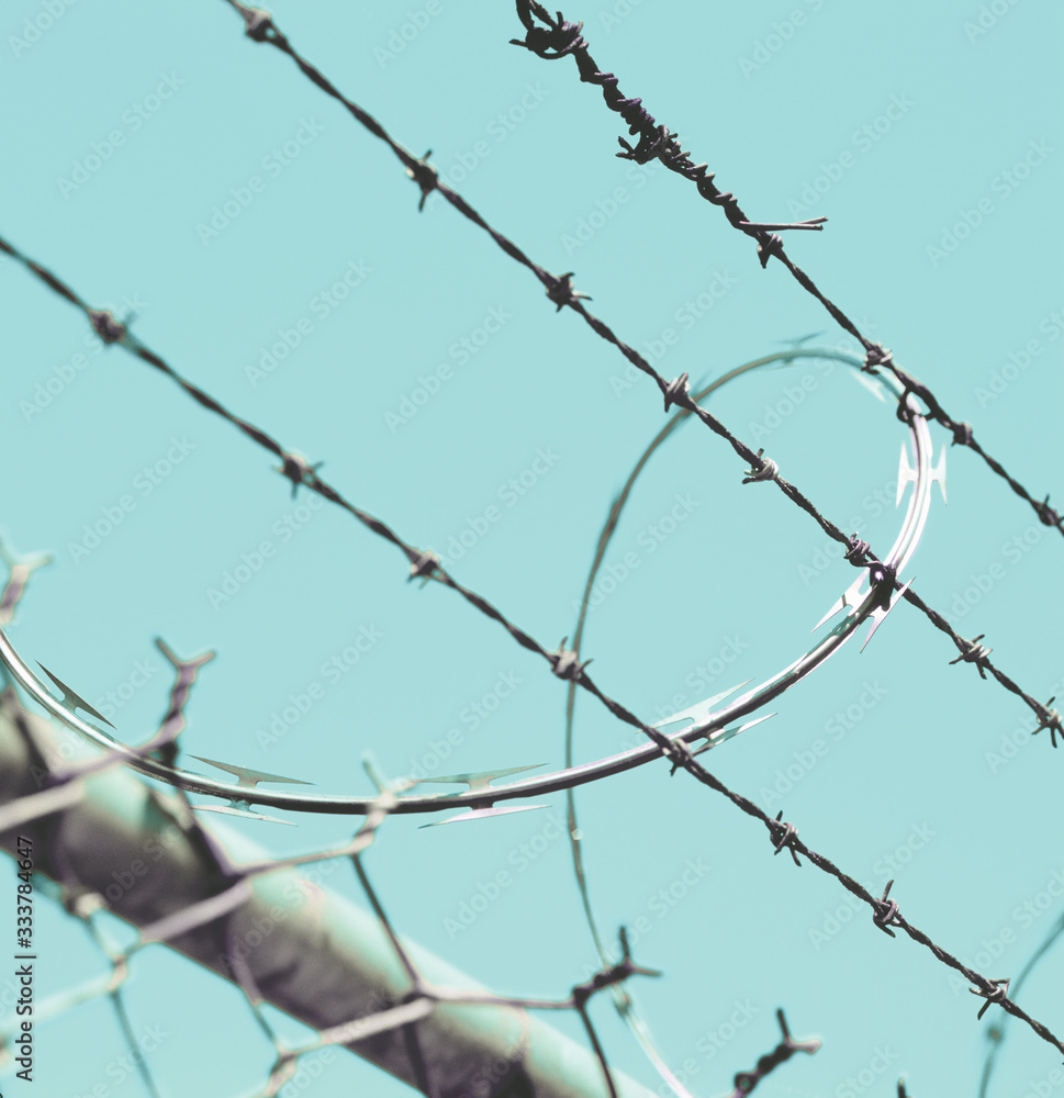Barbed wire and razor wire on chain link fence. Security, prison ...