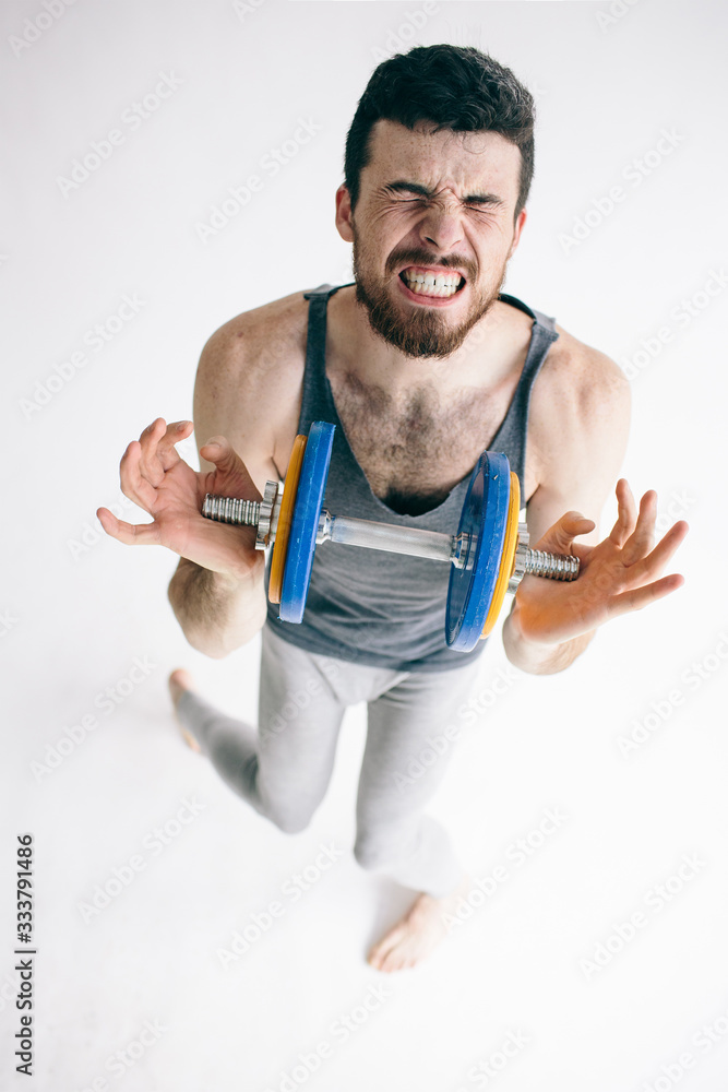 Skinny man training his bicep muscle. Guy lifting one dumbbell. young ...