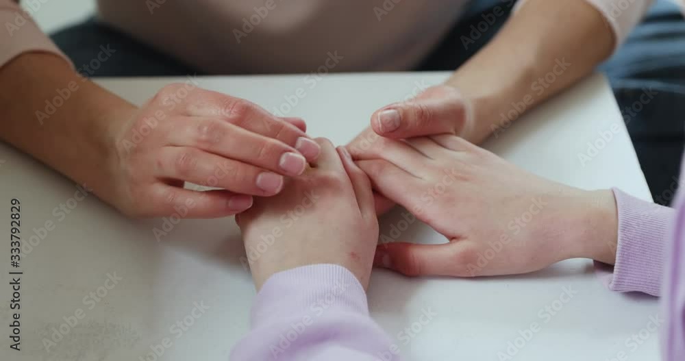 Caring mother holding hands stroking fingers of child daughter. Young ...
