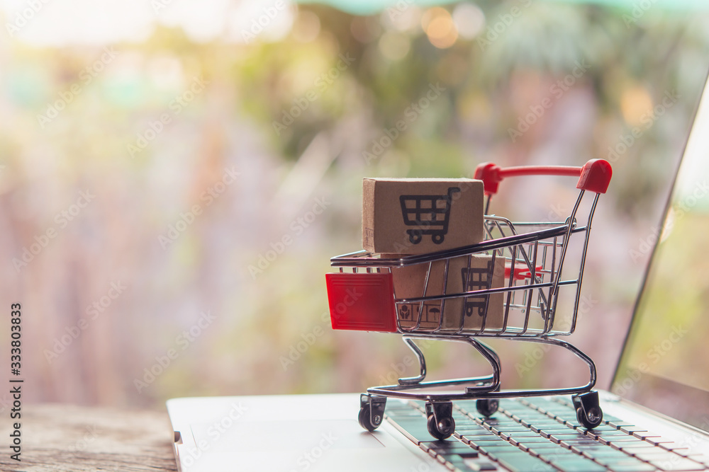 Shopping online concept - Parcel or Paper cartons with a shopping cart ...