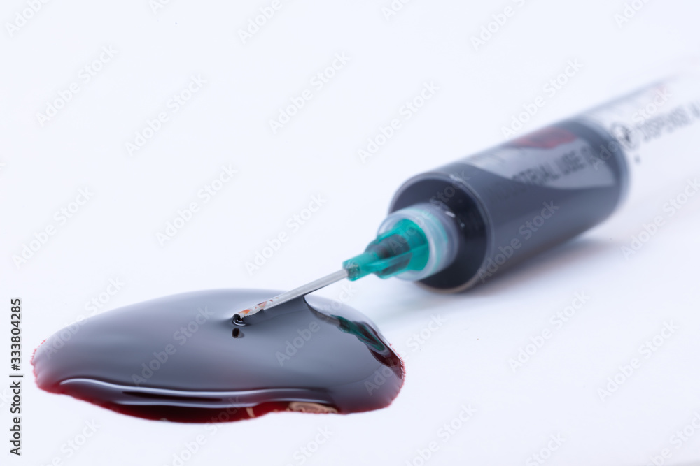 Blood spills out of a syringe Stock Photo | Adobe Stock