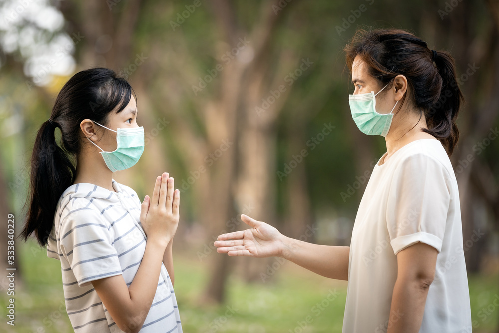 Child girl raise their hands to pay respect or greet instead of shaking ...