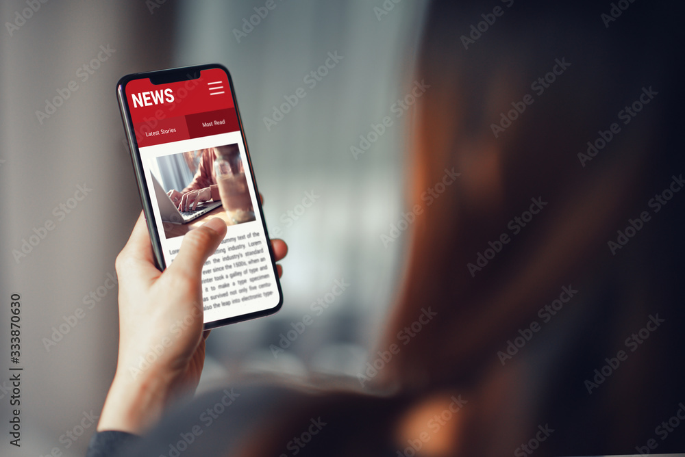Online news on a smartphone. Mockup website. Woman reading news or ...