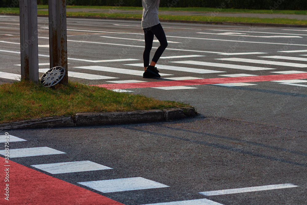 City intersection with pedestrian crossings and red bike lanes with ...