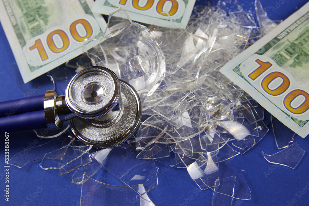 Health care system collapse concept: us dollar money bill notes on pile ...