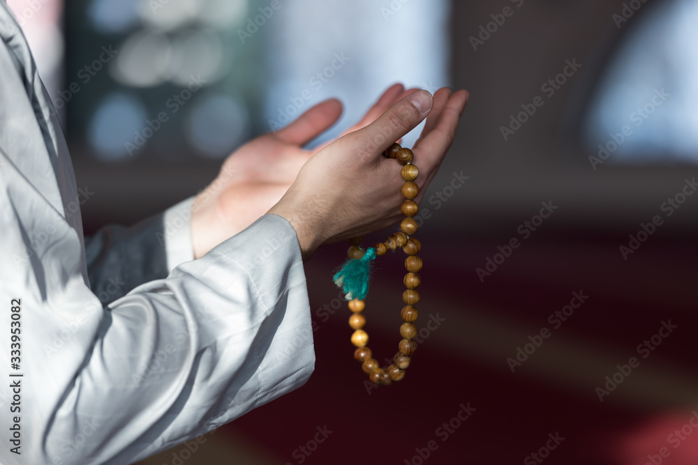 Young Arabic Muslim man praying. Doing a dailly pray inside modern ...