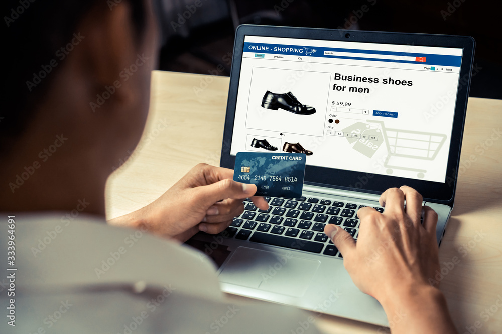 Young man use credit card for shopping payment online on laptop ...