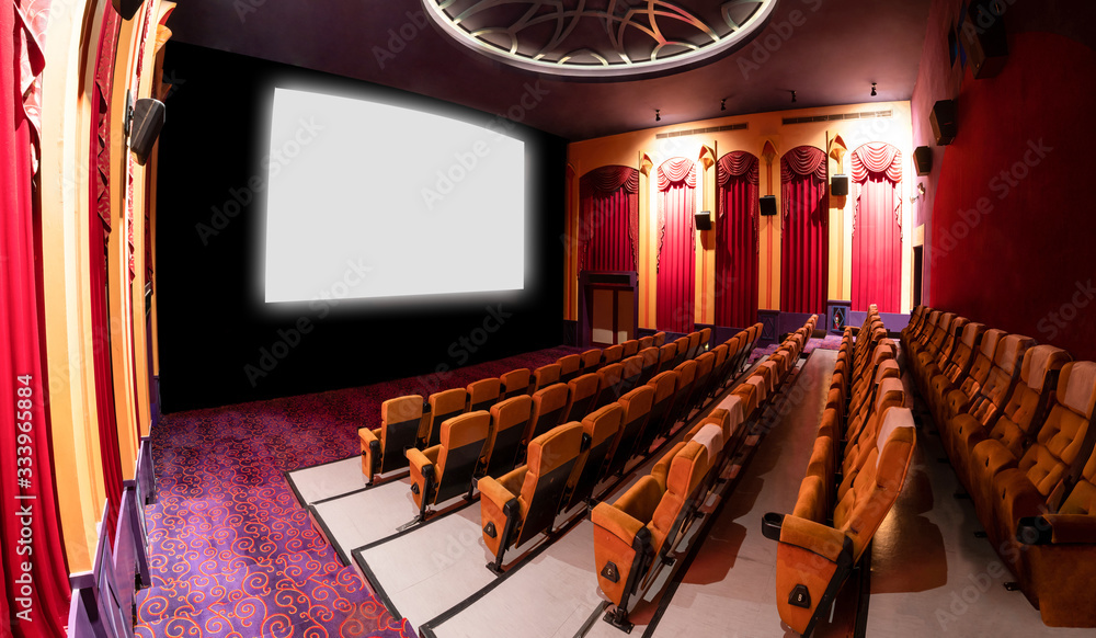 Cinema theater screen in front of seat rows in movie theater showing ...