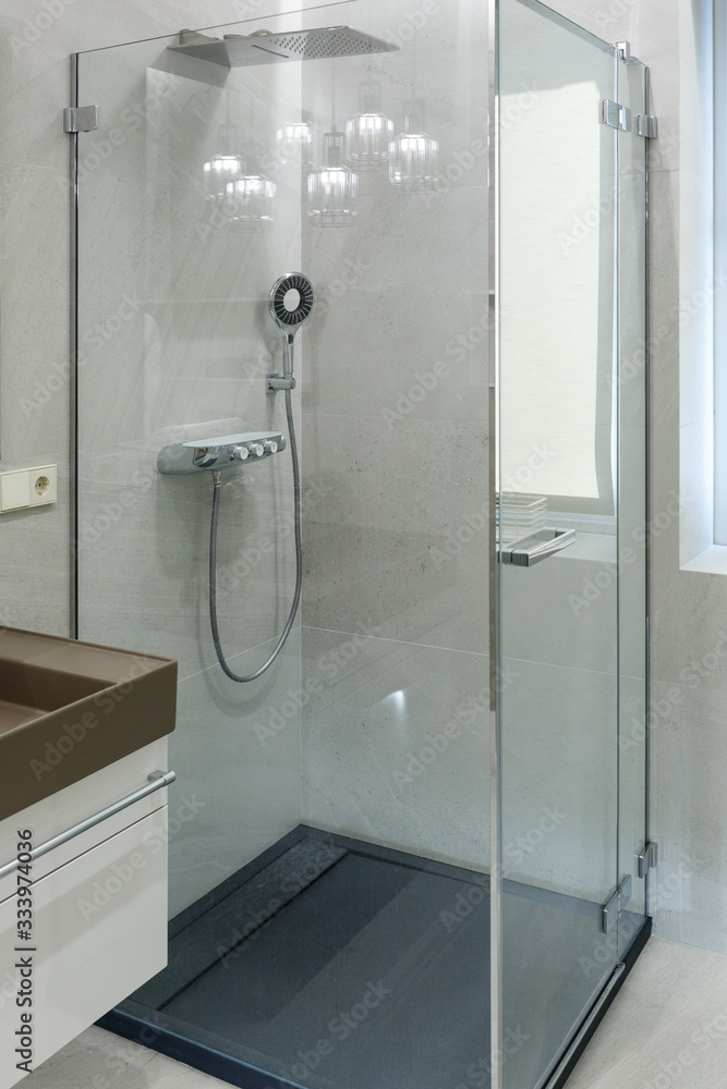 Shower cabin with transparent glass walls, rain shower and shower head ...