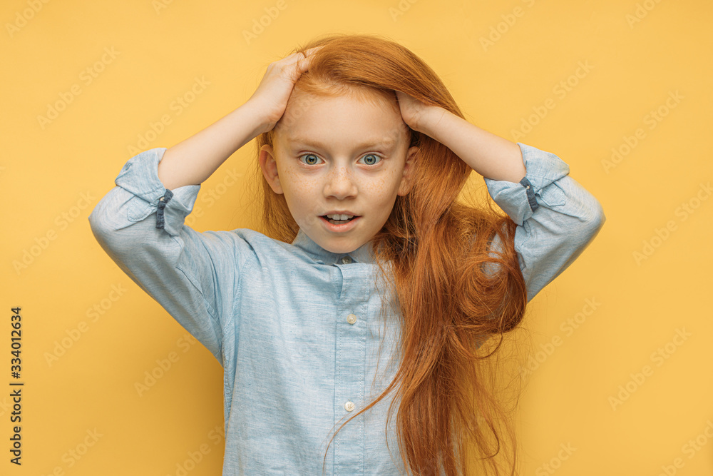 caucasian surprised red haired girl isolated over yellow background ...