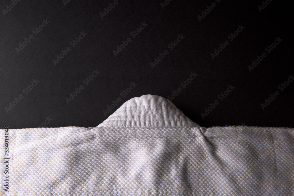 White judo uniform on black background Stock Photo | Adobe Stock