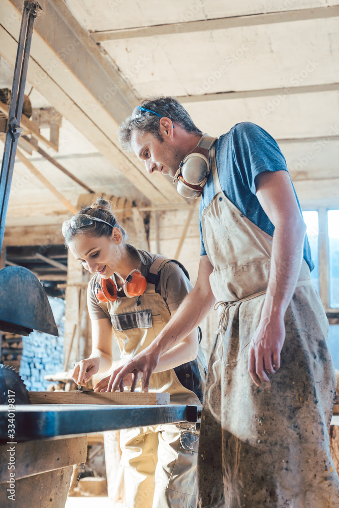 Team of carpenters working on details of a wood cut Stock Photo | Adobe ...