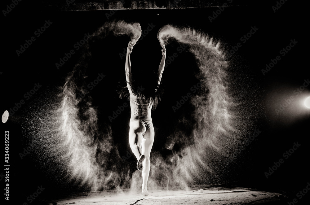 The girl with the flour on the body stretches the arms up with thrown ...