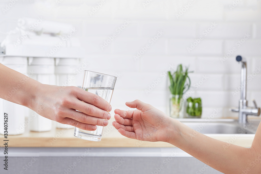 Female Hand giving a glass of clean water. Purified water and healthy ...