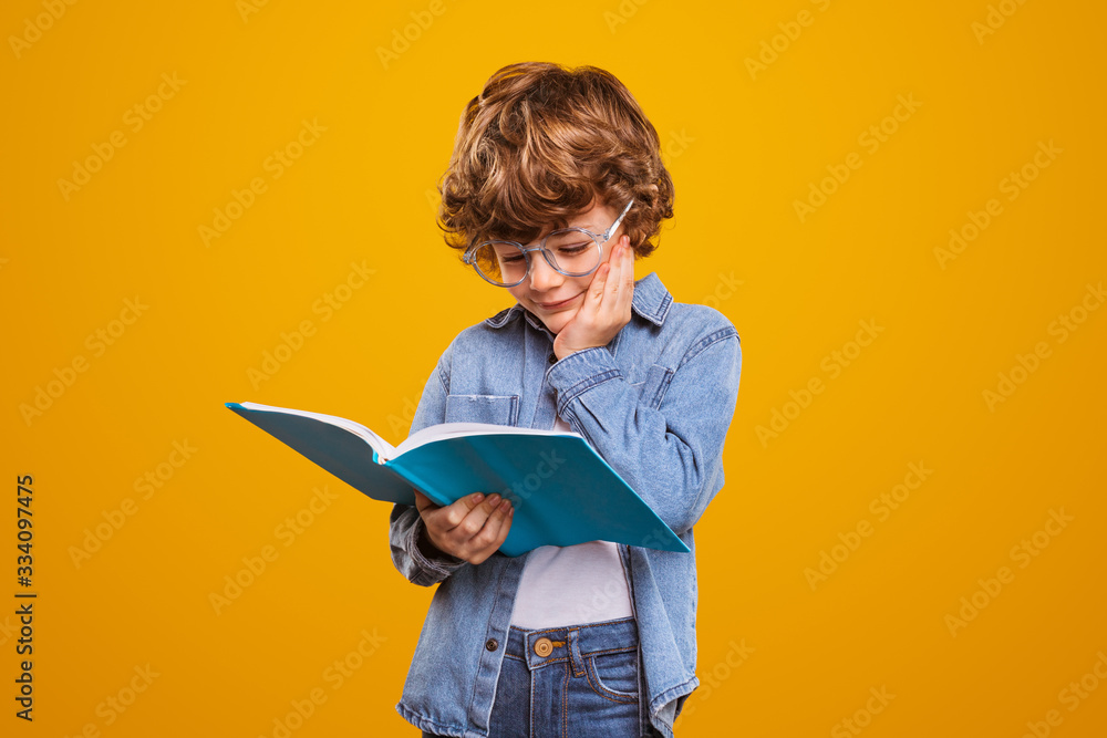 Little boy reading interesting book Stock Photo | Adobe Stock