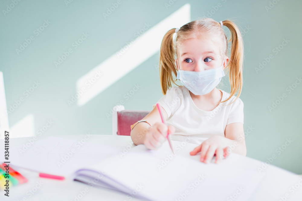 Home schooling learning during virus pandemic. Little girl drawing at ...