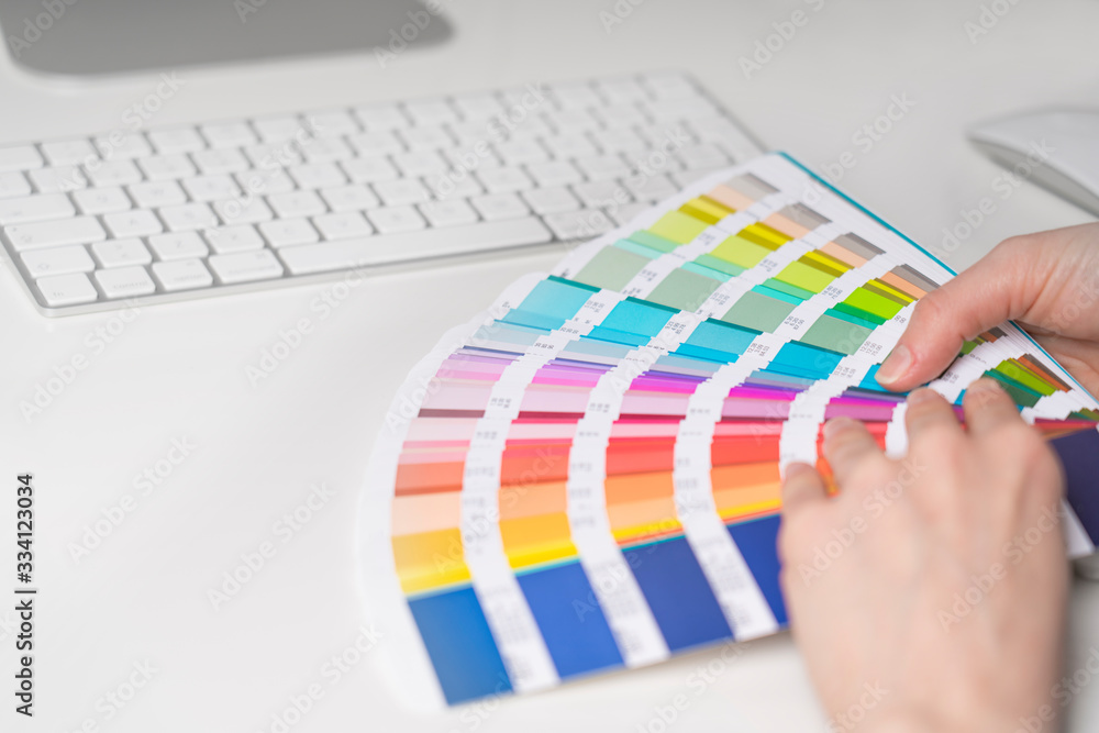 Graphic designer works on the choice of palette colors for creative ...