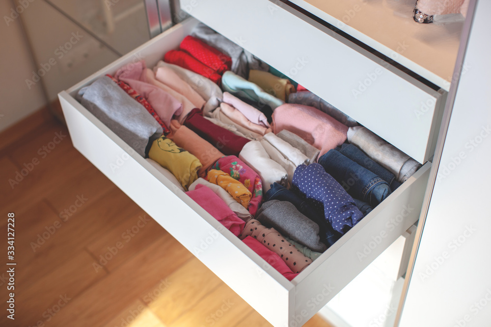 Vertical storage of clothing. children's room. Clothing folded for ...
