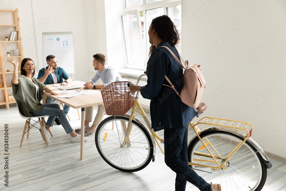 African American young female employee come to workplace office using ...