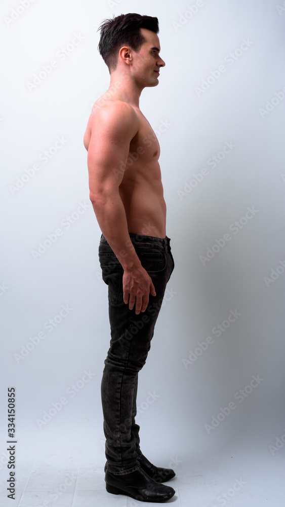 Full body shot profile view of young handsome muscular man shirtless ...