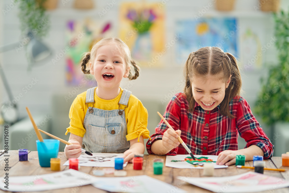 Happy kids are painting at home. Stock Photo | Adobe Stock