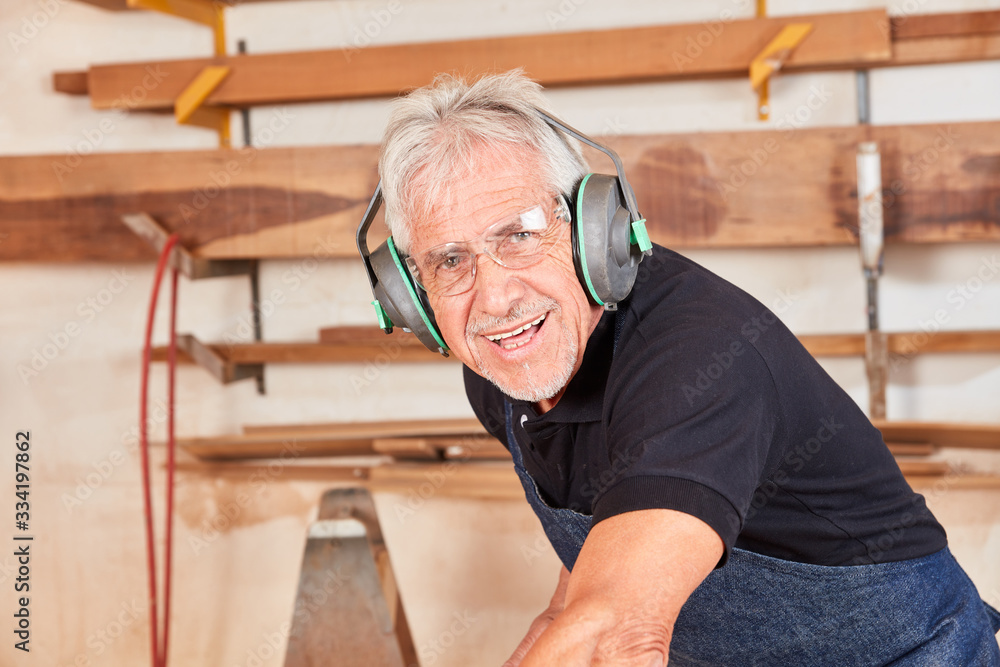 Smiling carpenter master with ear protection Stock Photo | Adobe Stock