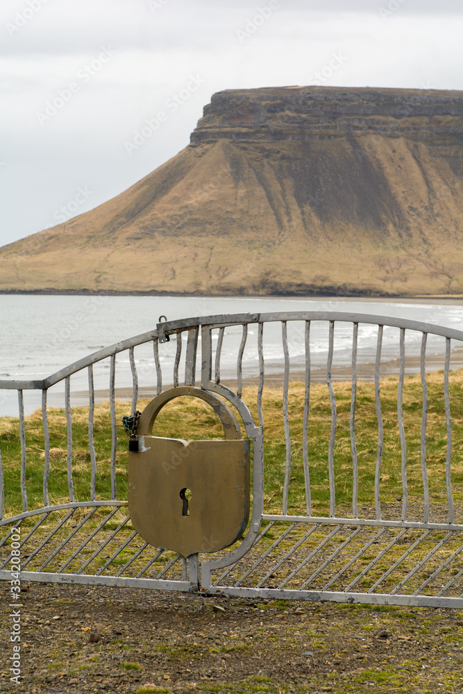 Gate with padlock on Olavsvik, a typical Icelandic town in the ...