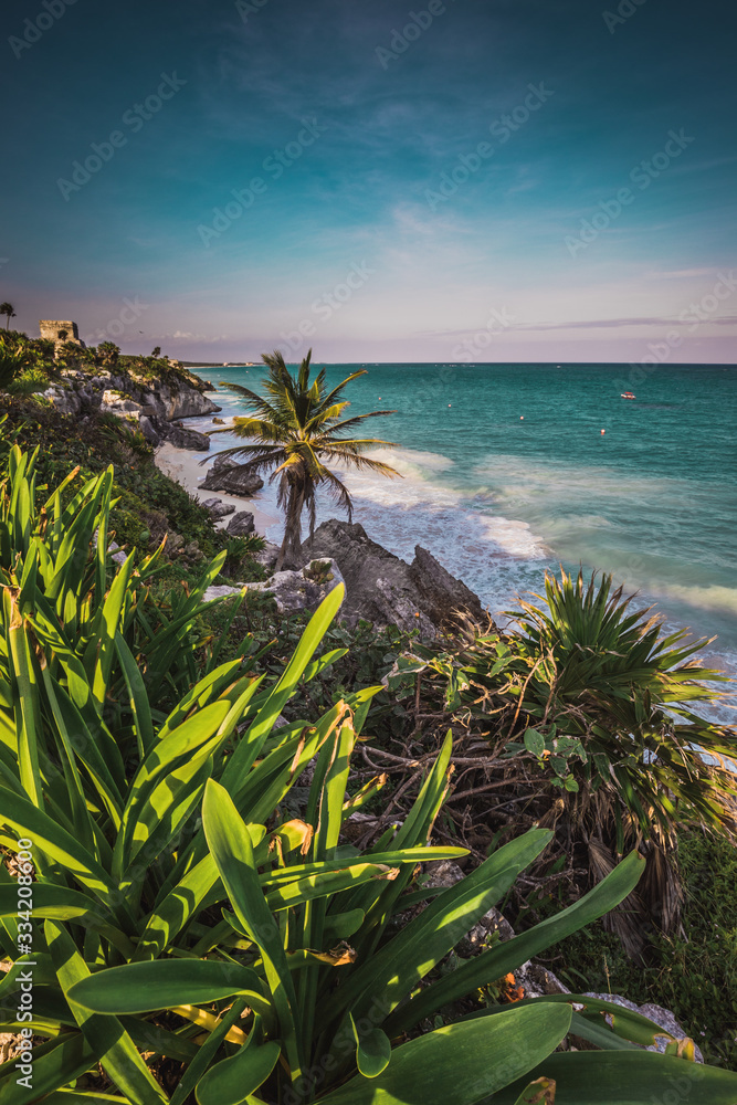 Sunset view at Mayan ruins of Tulum at tropical coast. El Castillo ...