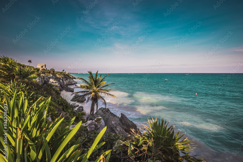 Sunset view at Mayan ruins of Tulum at tropical coast. El Castillo ...