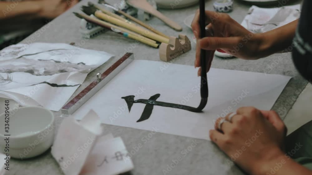Women hands painting Japanese style. Traditional Japanese calligraphy ...