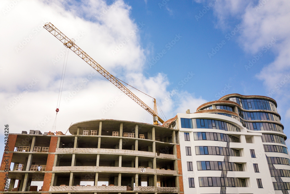 Apartment or office tall building under construction. Brick walls ...