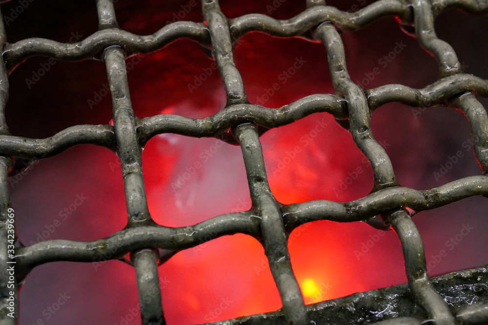steel grate for grilling food on Smoke dry ice and red and orange light ...