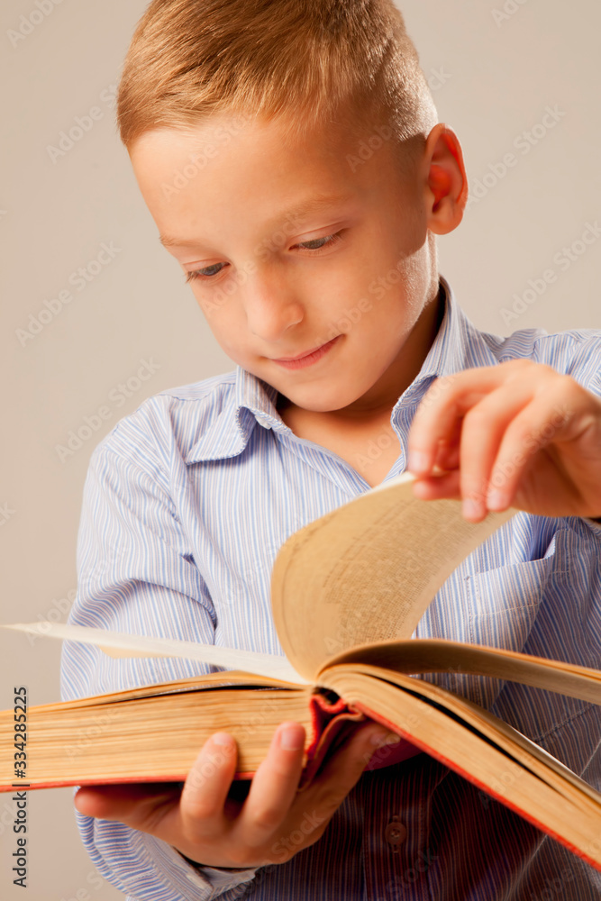 Little boy reading book as symbol of motivation to success and self ...