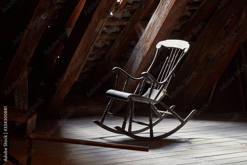 Old rocking chair on a dim attic window light Stock Photo | Adobe Stock