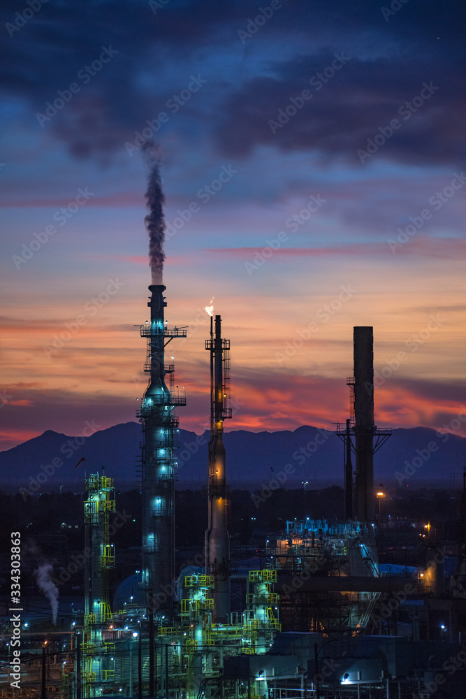 Steam Smokestack and Flame at Refinery with Mountains and Sunset Stock ...