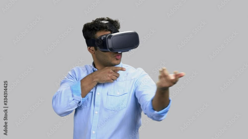 Man wearing vr-headset and playing shooter game. Young dark-skinned guy ...