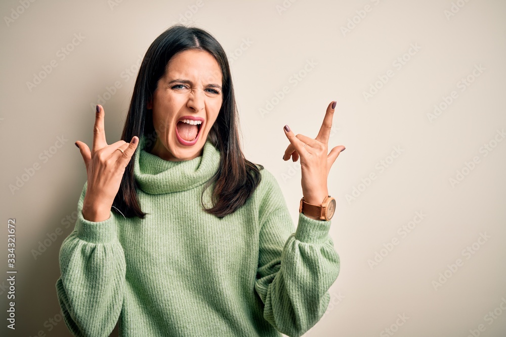 Young brunette woman with blue eyes wearing turtleneck sweater over ...