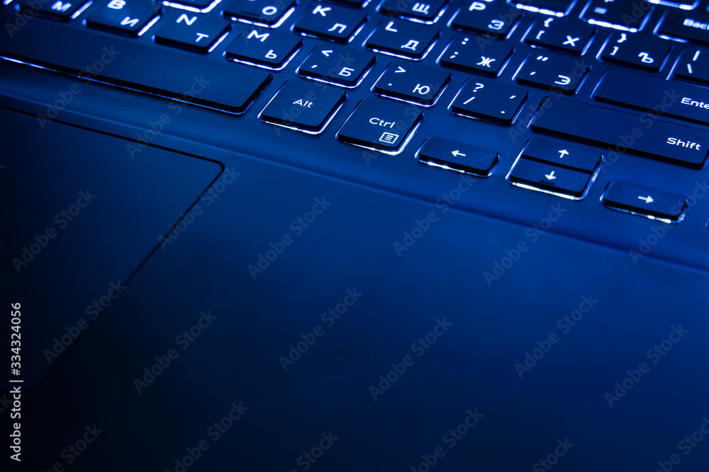 laptop keyboard white illumination dark blue computer surface ...