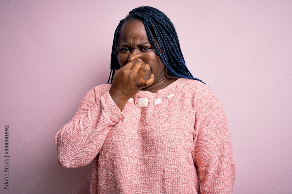 African american plus size woman with braids wearing casual sweater ...