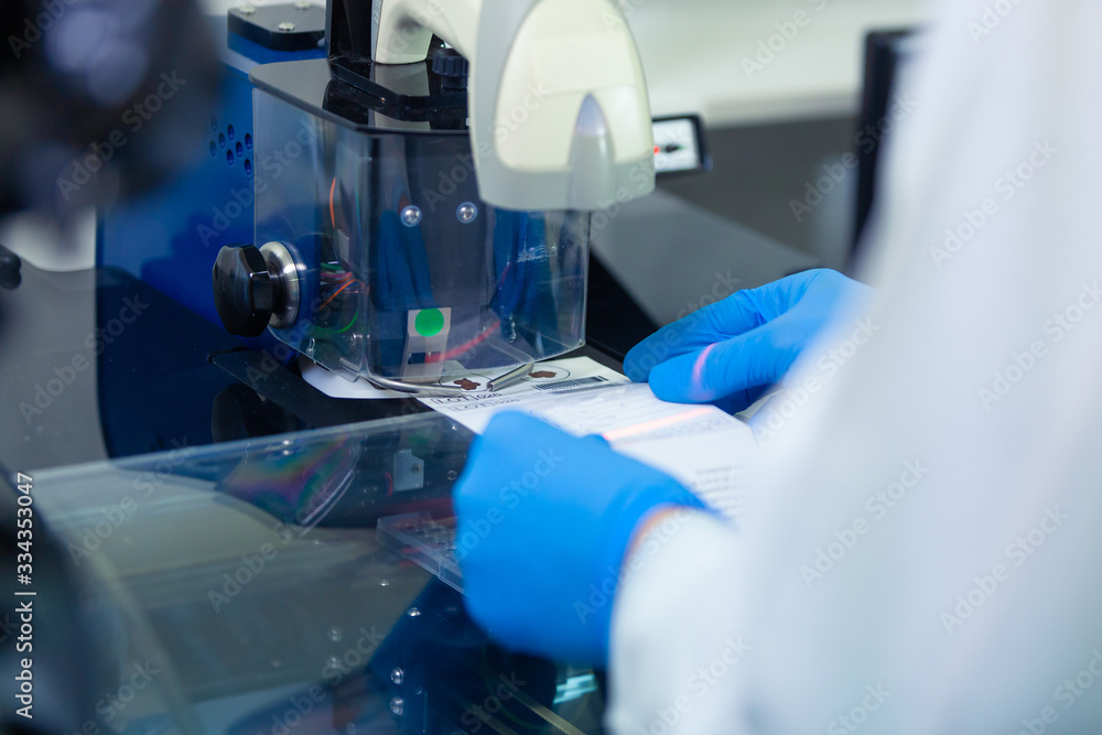 DNA laboratory. The expert puts the human DNA into the database using ...