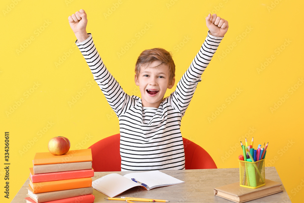 Happy little boy with his homework done at table Stock Photo | Adobe Stock