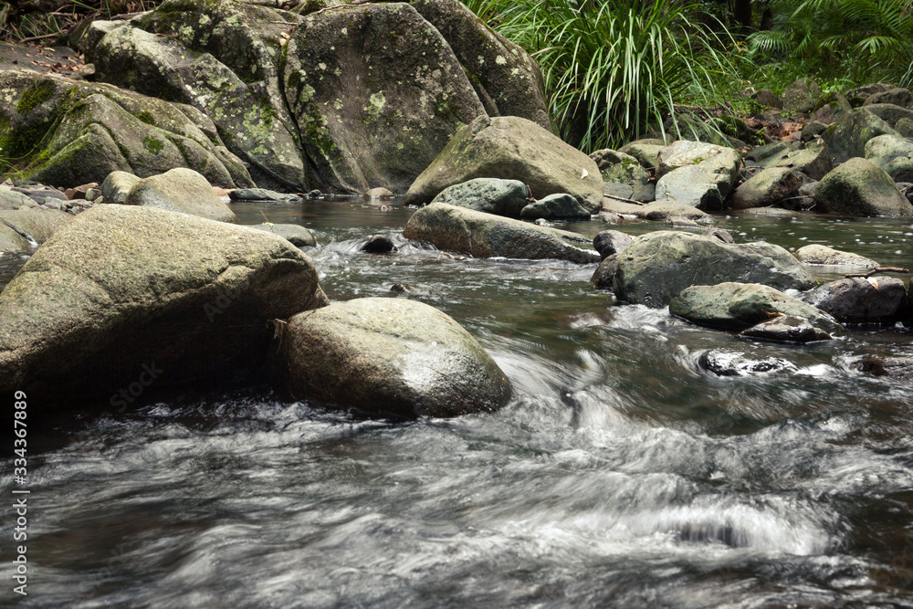 Peaceful and idyllic, water splashes and streams around and over the ...