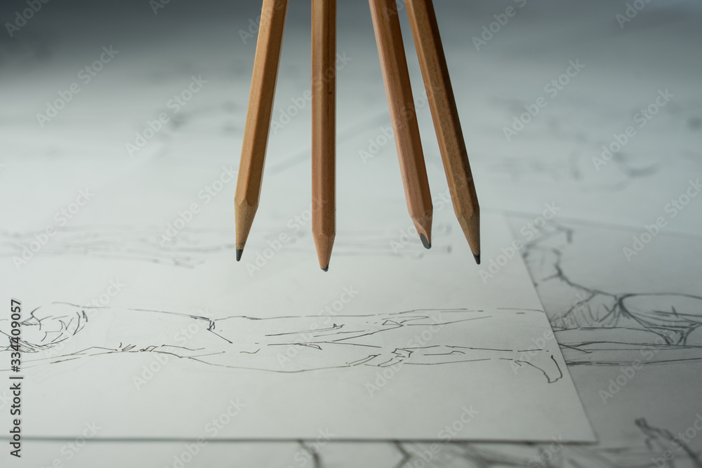 A top view flat lay of many figure drawing pencil and marker sketches ...