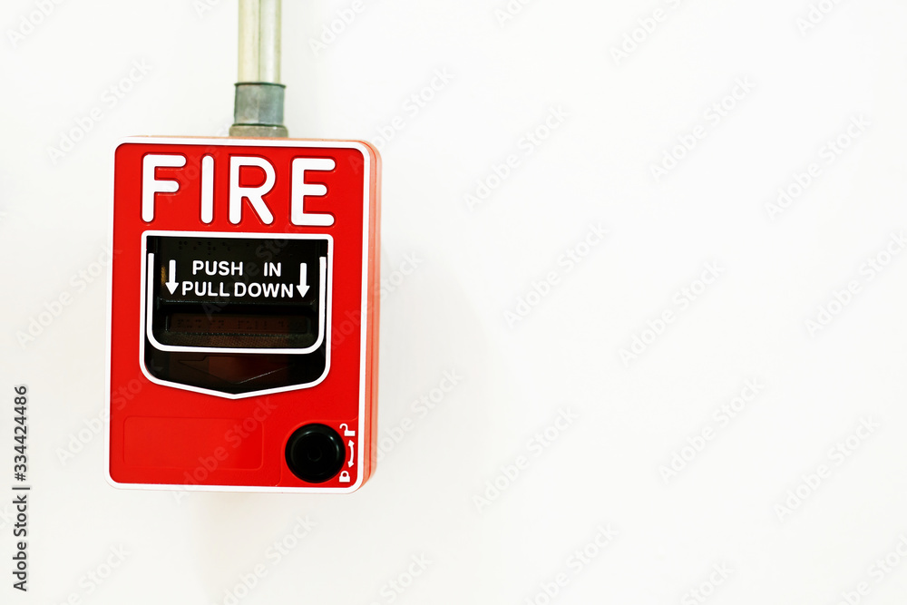 Manual pull fire alarm switch safety system box installed on white wall ...