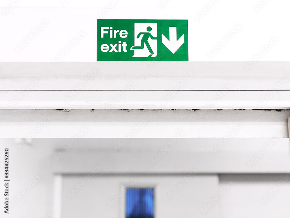 Fire Exit sign on the wall entry the room, green safety symbol icon ...