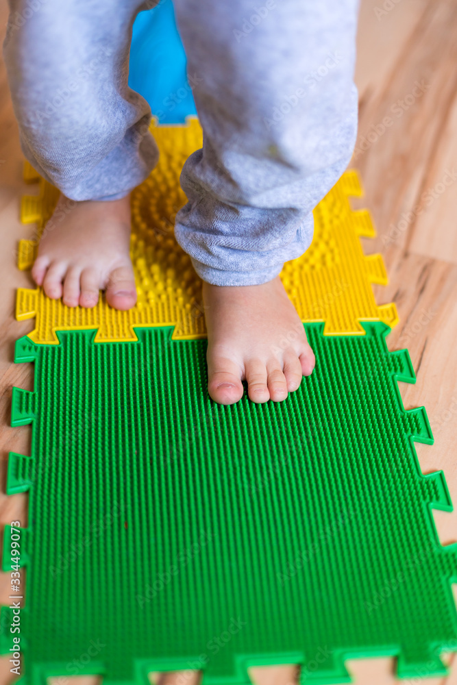 Orthopedic foot mat for child gymnastic. Small children with a flat ...